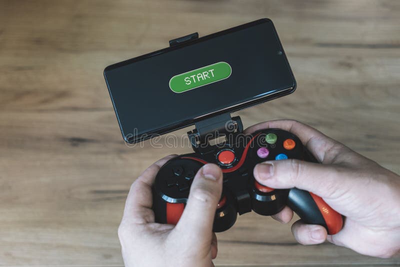 A Gamer Plays on a Smartphone. Hands with Joystick with Phone Stock ...