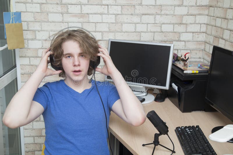 Gamer. a Young Man is Sitting at a Computer and Playing Computer Games ...