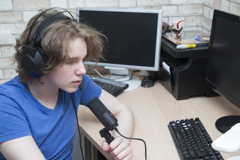 Gamer. a Young Man is Sitting at a Computer and Playing Computer Games ...