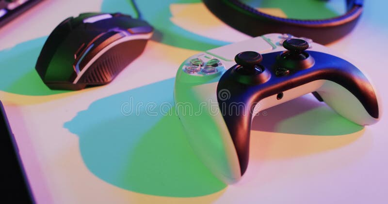 A Gaming Controller and Mouse Rest on a Colorful Surface Stock Photo ...