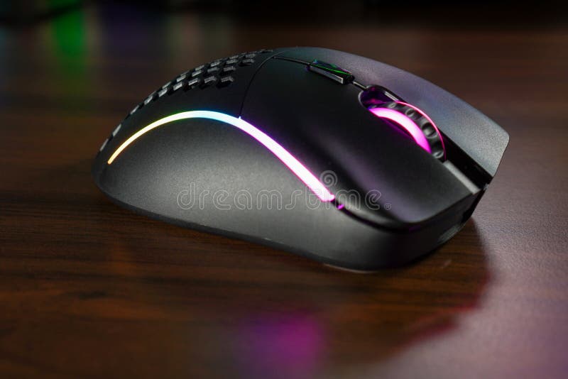 RGB Gaming Mouse with Colorful Light Reflections on the Table Stock ...