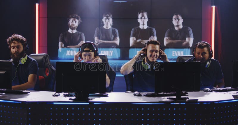 Gaming Team Sitting Down at Computers Stock Photo - Image of ...