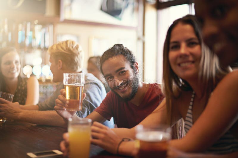 The Gang is All Here. a Group of Friends Enjoying Themselves in the Bar ...