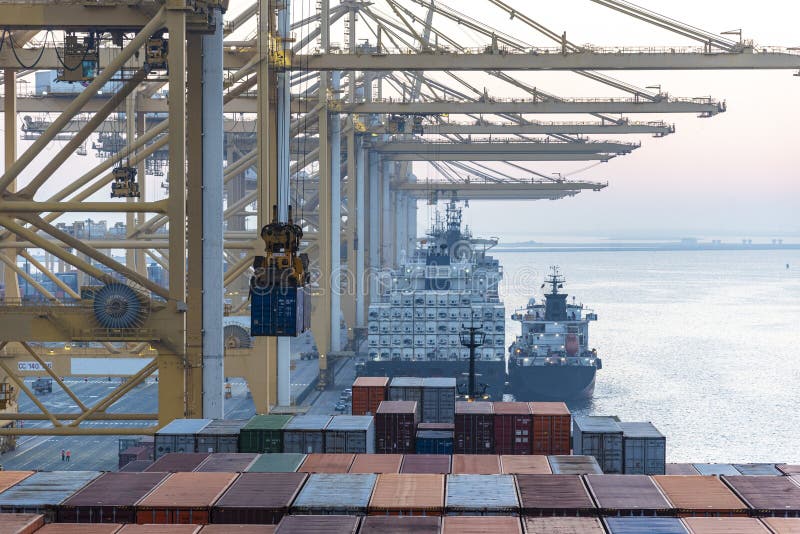 Gantry Cranes are Loading Cargo in the Containers on Deck of a Cargo ...