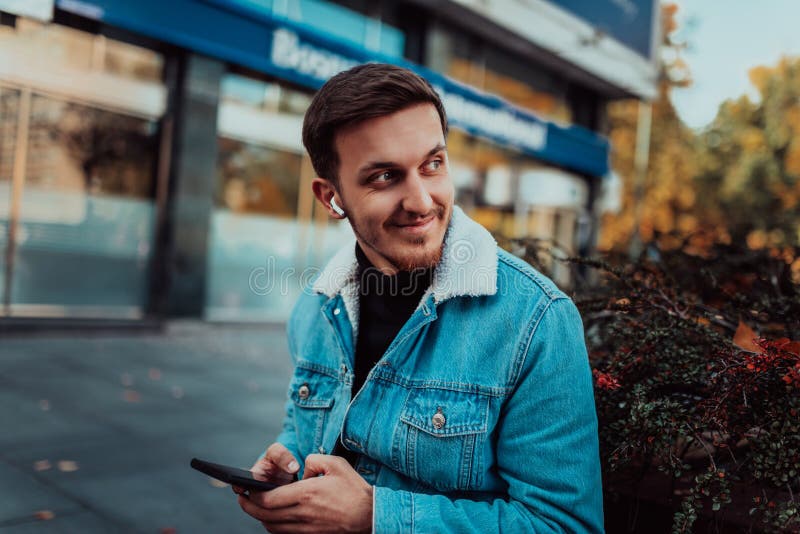 A Gappy Student Sitting in a Park Using a Smartphone and Wireless ...