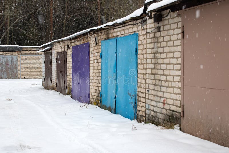 Garage Doors in a Row in the Snow Stock Photo - Image of gate ...