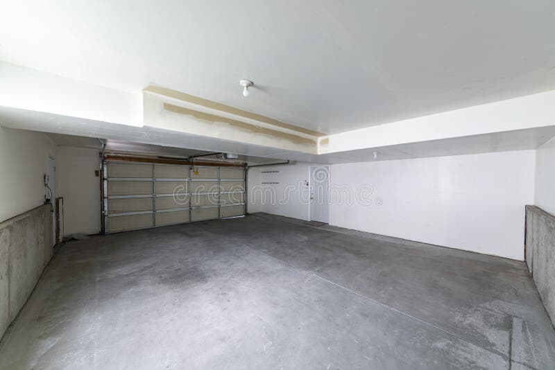 Garage Interior with Automatic Sectional Door and White Fire Door Stock ...