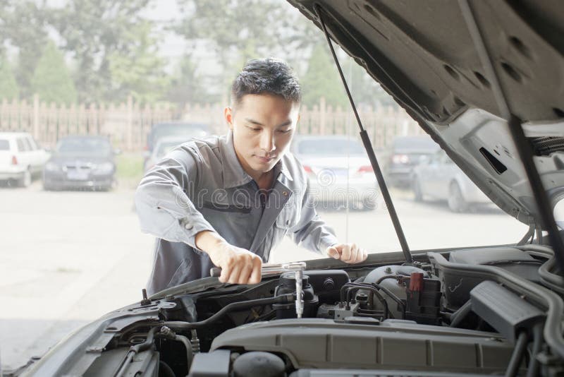 Garage Mechanic Working on Engine Stock Image - Image of looking, front ...