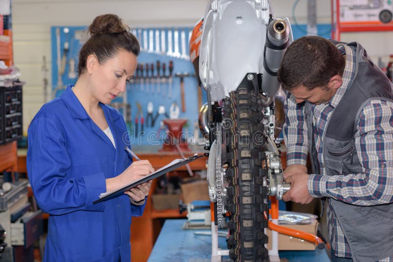 Garage Mechanics Working on Motorcycle Stock Photo - Image of work ...