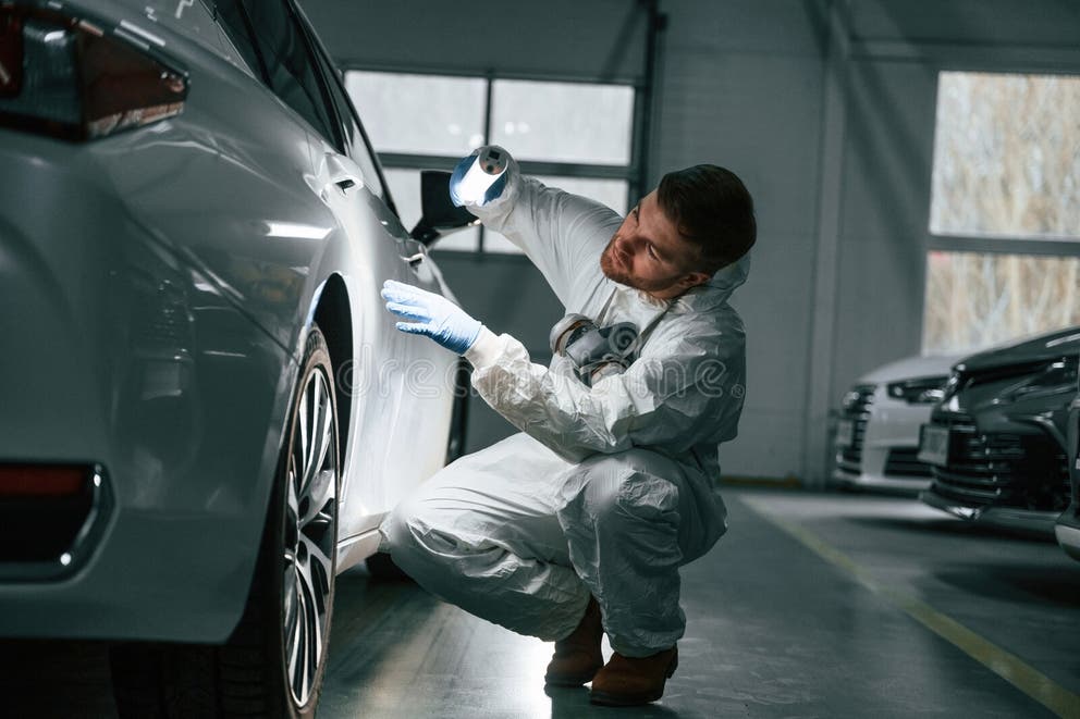 Garage Worker is Holding Lighting and Checking Surface of the Car Stock ...