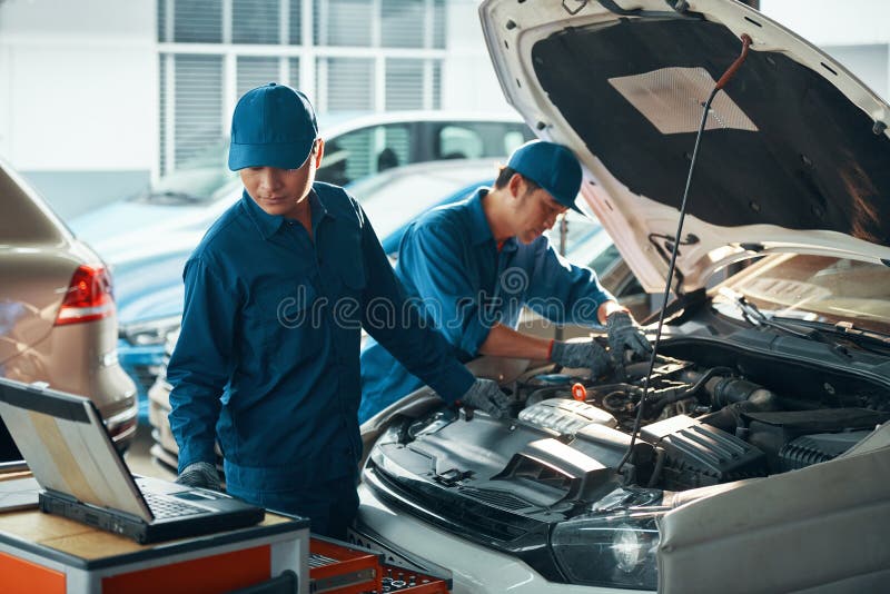 Garage Workers Repairing Car Stock Photo - Image of engineer ...