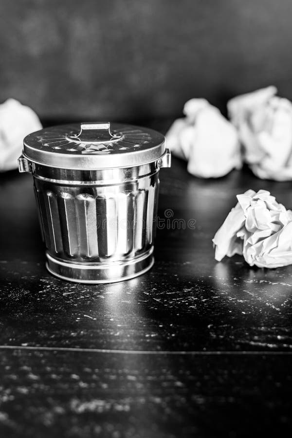Garbage Bin on Desk Setting and Scrunched Paper Balls Around it Stock ...