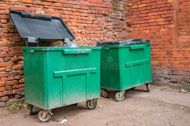 Garbage Cans Near an Old Brick Wall on a City Street Stock Image ...
