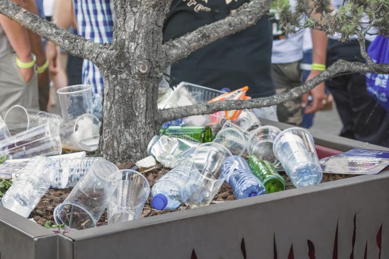 Garbage from Cans and Plastic and Paper in a Pot with a Tree Stock ...