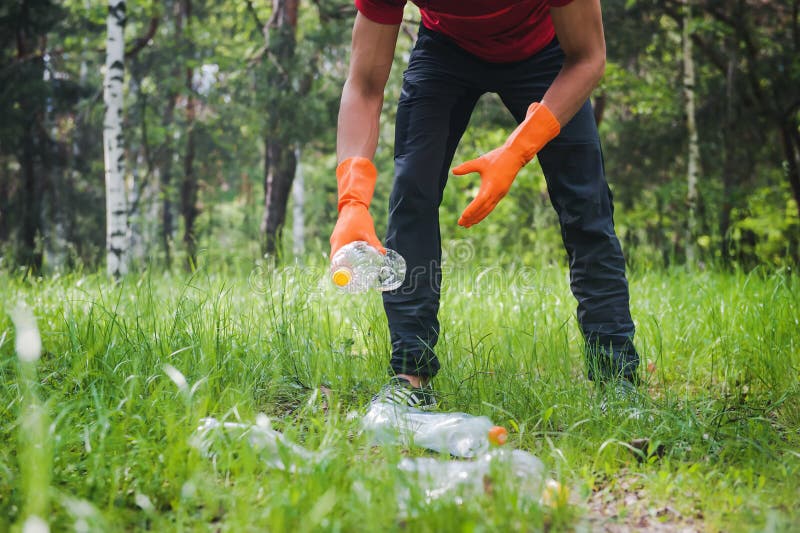 Garbage Collection in Nature. Young Man Collects Plastic Trash in ...