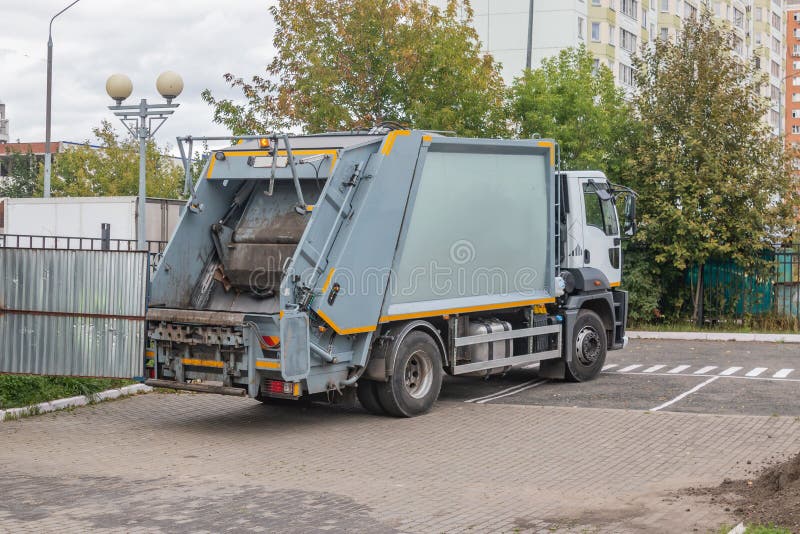 Garbage Collection Service, a Waste Collector Working on Emptying ...
