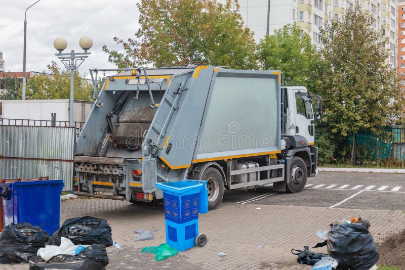 Garbage Collection Service, a Waste Collector Working on Emptying ...