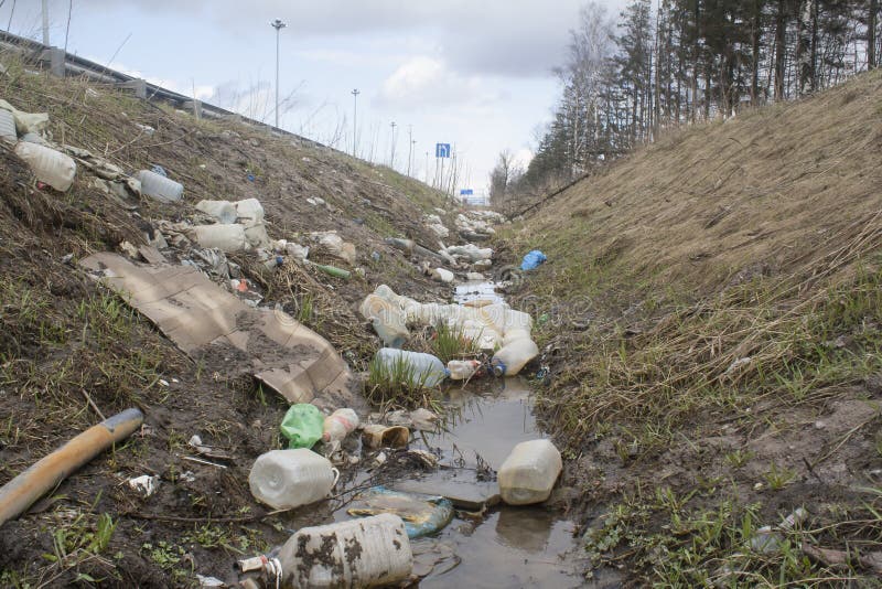 Trash in a roadside ditch stock photo. Image of garbage - 115959062