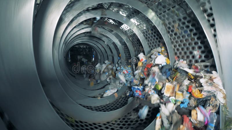 Process of Mechanical Garbage Sorting. Trash Falls from a Conveyor into ...