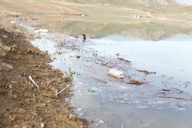 Garbage on the lake stock image. Image of bottles, dirty - 217302107