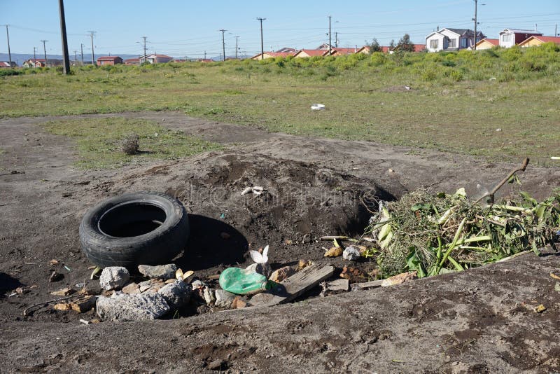 Garbage mixed in a hole editorial photography. Image of tire - 141043932