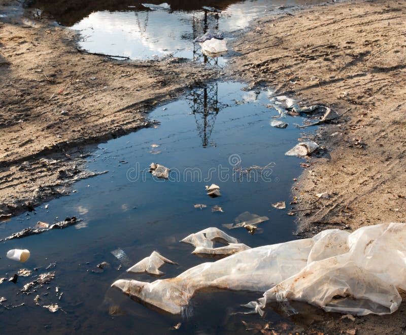 Garbage in the Mud on the Dirt Road Stock Photo - Image of garbage ...