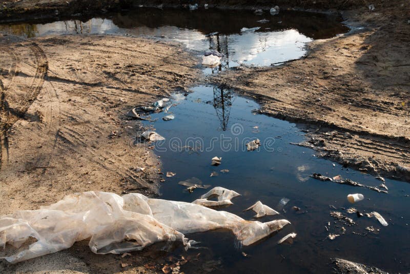 Garbage in the Mud on the Dirt Road Stock Photo - Image of plastic ...