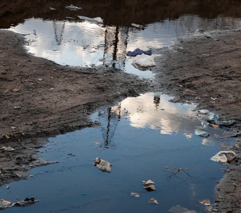 Garbage in the Mud on the Dirt Road Stock Image - Image of muddy ...