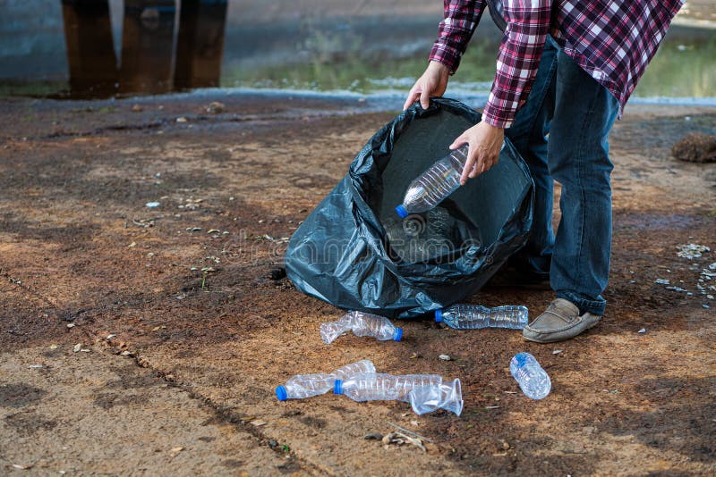 Garbage Picker`s Hand. Empty Plastic Water Bottle Simmering on the ...