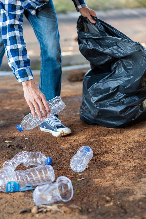 Garbage Picker`s Hand. Empty Plastic Water Bottle Simmering on the ...