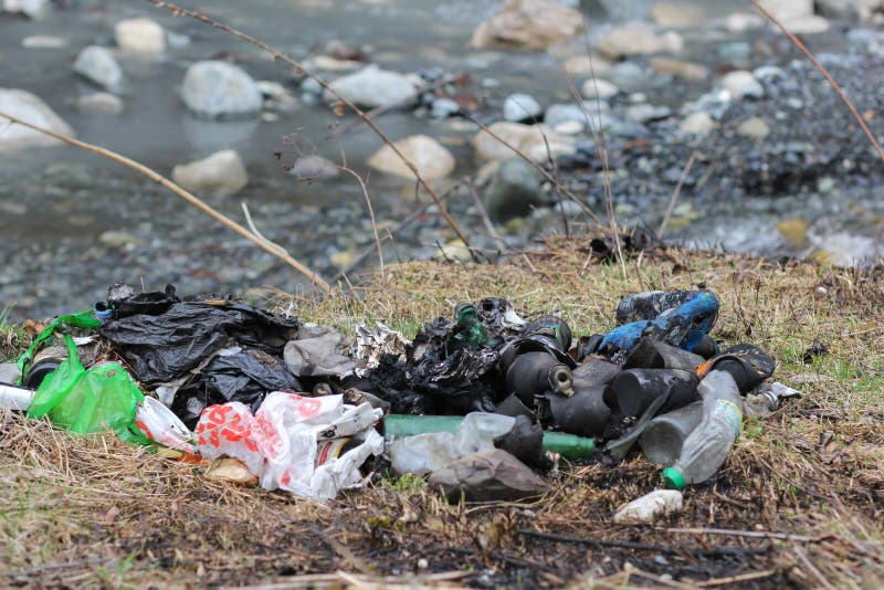 Garbage on river bank stock photo. Image of deposit - 280413994