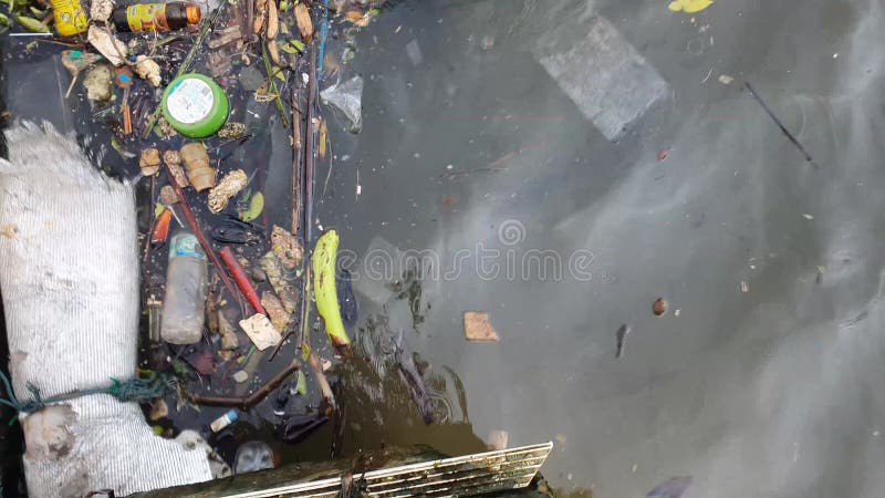 Garbage in the River, Floating Garbage Causes Water Pollution. Stock ...