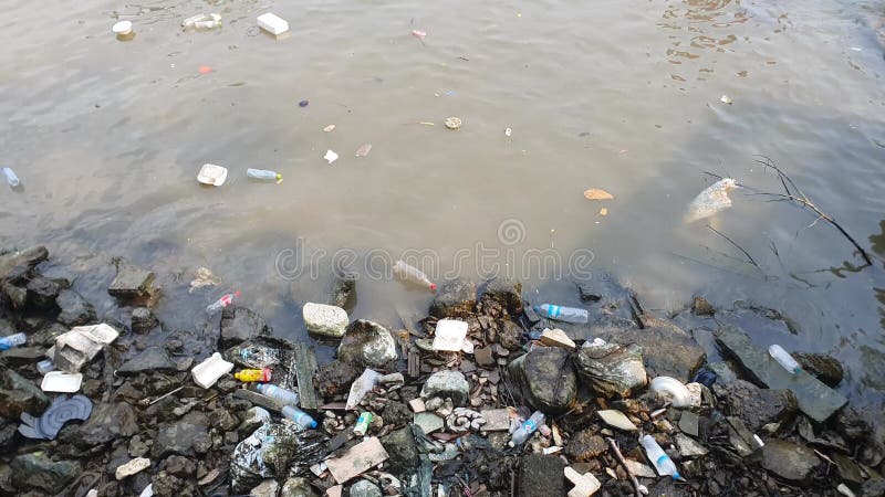 Garbage in the River, Floating Garbage Causes Water Pollution. Stock ...