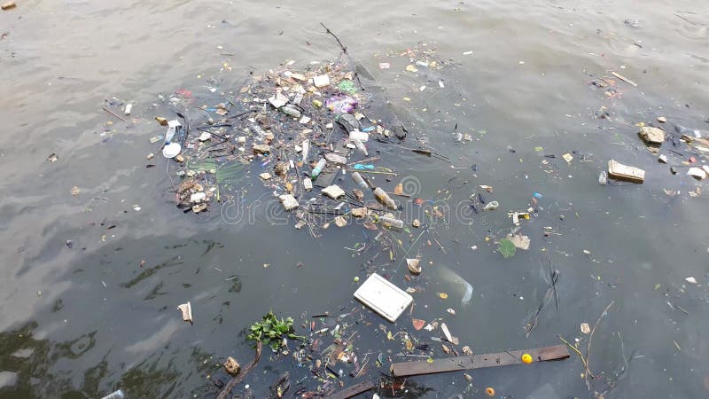 Garbage in the River, Floating Garbage Causes Water Pollution. Stock ...
