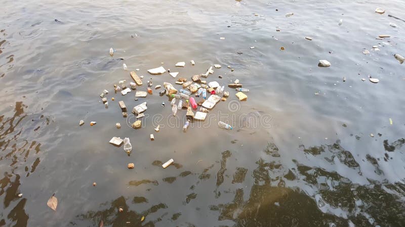 Garbage in the River, Floating Garbage Causes Water Pollution. Stock ...