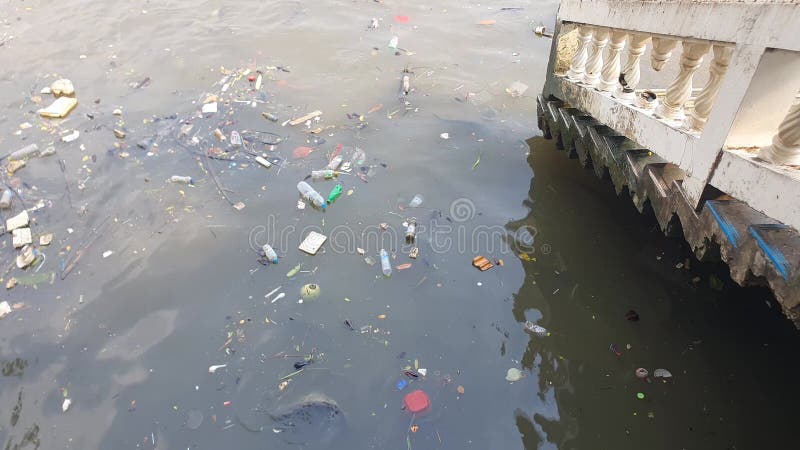 Garbage in the River, Floating Garbage Causes Water Pollution. Stock ...