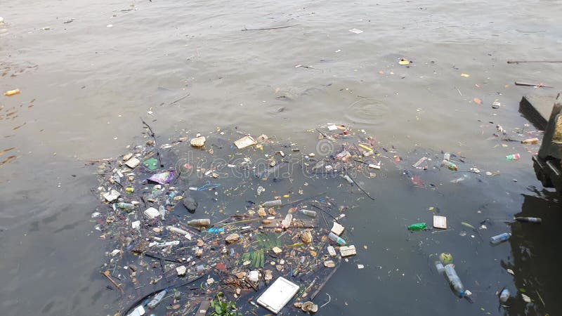 Garbage in the River, Floating Garbage Causes Water Pollution. Stock ...