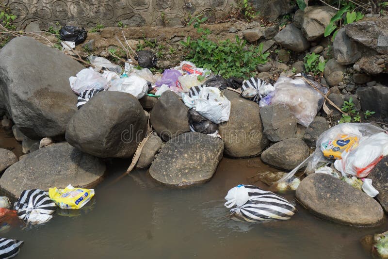 The Garbage in the River with Rock Background Editorial Photography ...