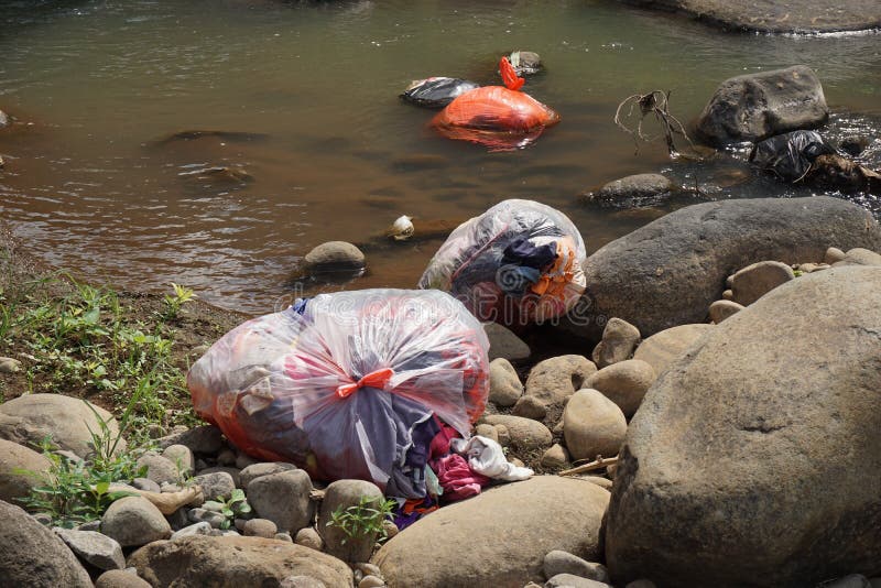 The Garbage in the River with Rock Background Editorial Photography ...