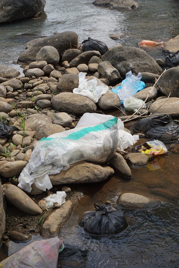 The Garbage in the River with Rock Background Editorial Photography ...
