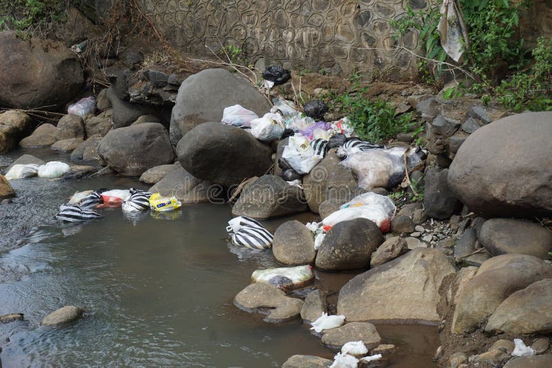 The Garbage in the River with Rock Background Editorial Photography ...