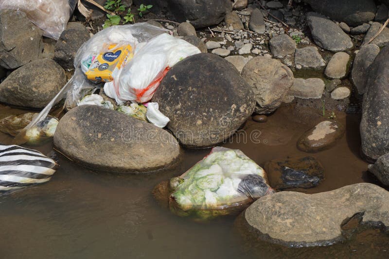 The Garbage in the River with Rock Background Editorial Photography ...