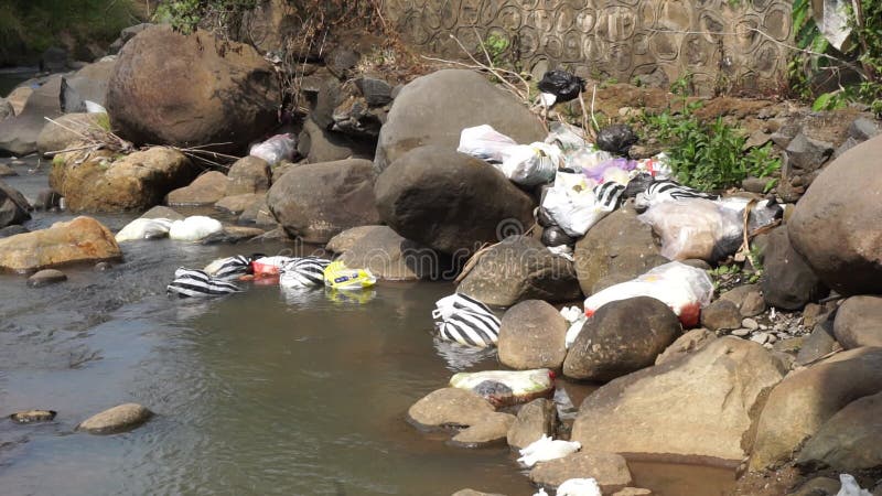 The Garbage in the River with Rock Background Stock Footage - Video of ...