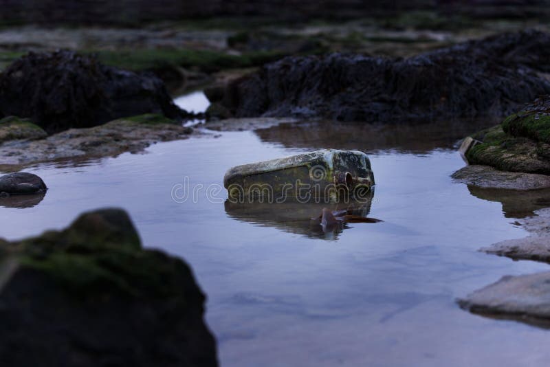 Garbage in River Surrounded by Rocks Stock Photo - Image of stones ...