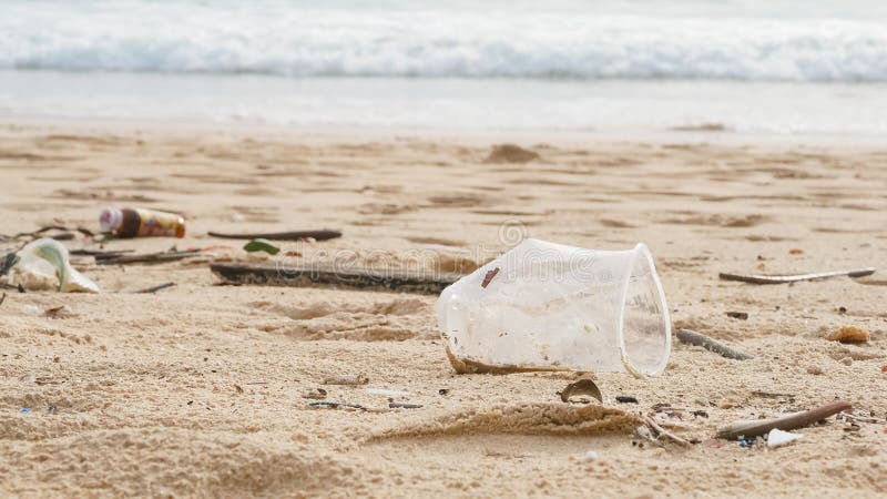 Garbage on sand beach stock photo. Image of coastline - 187480978
