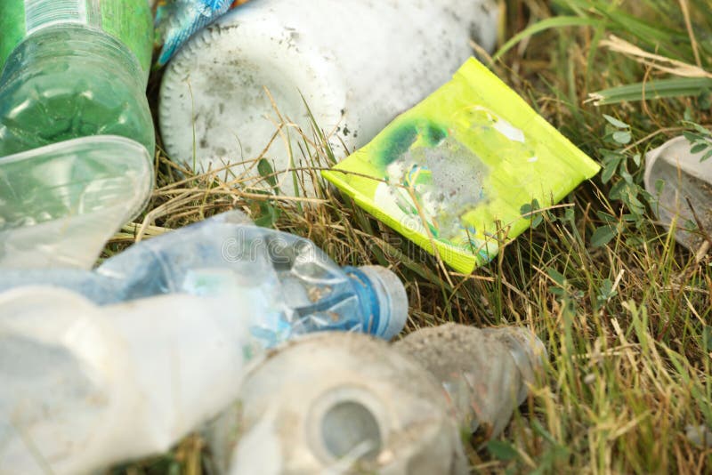 Garbage Scattered on Grass, Closeup. Environment Pollution Problem ... Garbage Scattered on Grass, Closeup. Environment Pollution Problem ...