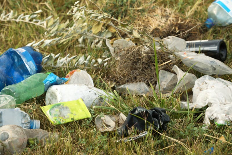 Garbage Scattered on Grass. Environment Pollution Problem Stock Photo ... Garbage Scattered on Grass. Environment Pollution Problem Stock Photo ...