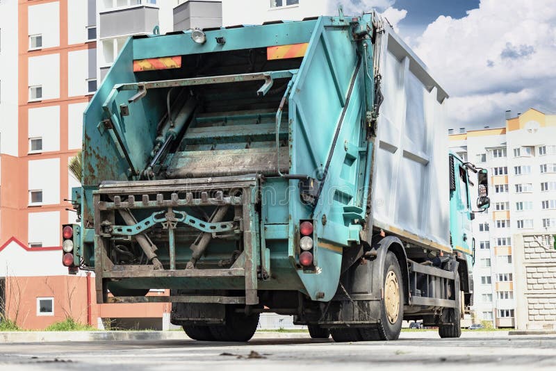 A Garbage Truck Picks Up Garbage in a Residential Area. Loading Mussar ...