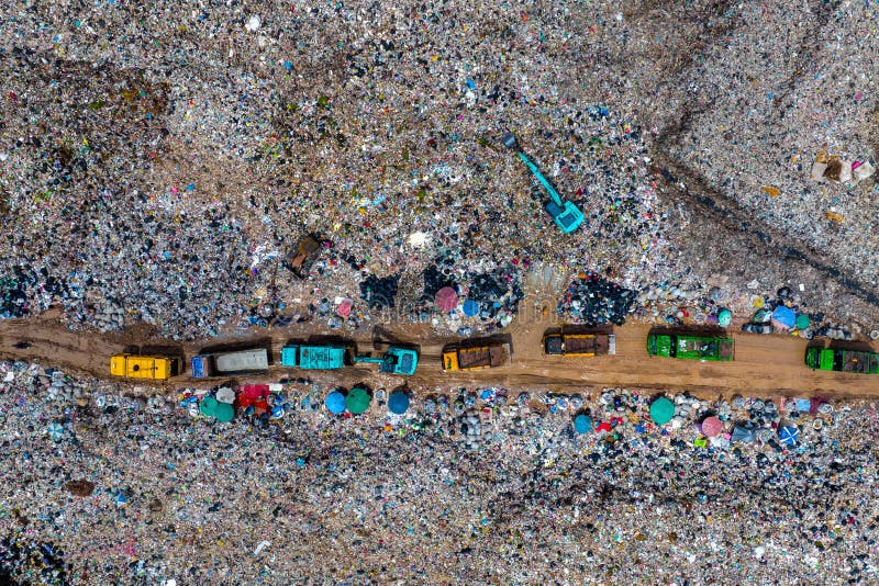 Garbage Trucks Unload Garbage Over the Landfill. Pollution Concept ...