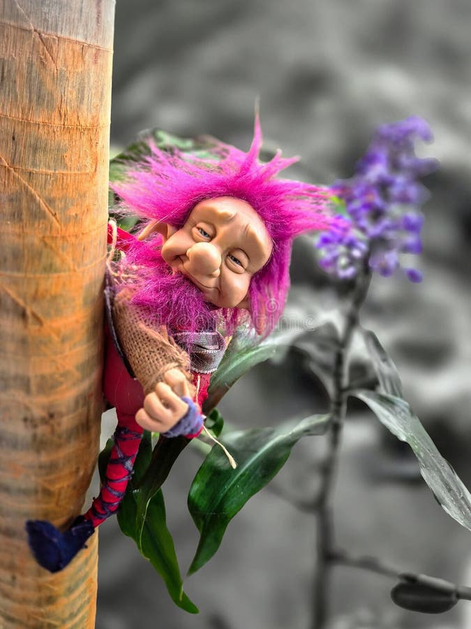 Garden Elf Climbing on Rustic Garden Log. Stock Image - Image of blue ...